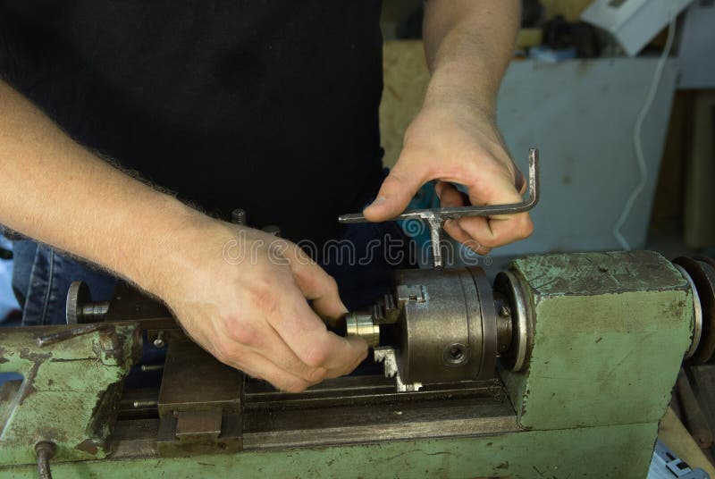 Working on a Lathe. Preparing and Setting Up the Machine. Hands of the ...