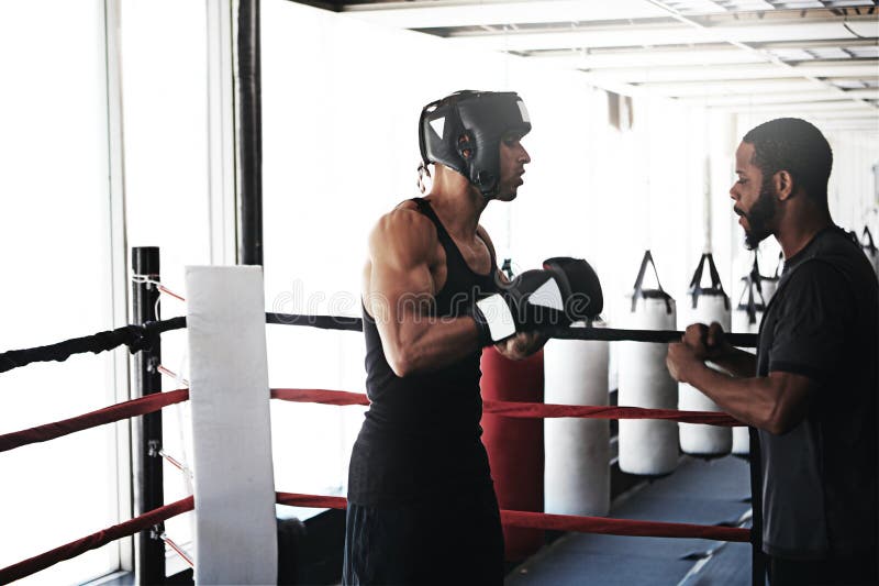 Preparing for a Showdown. a Man Training in the Boxing Ring with a ...