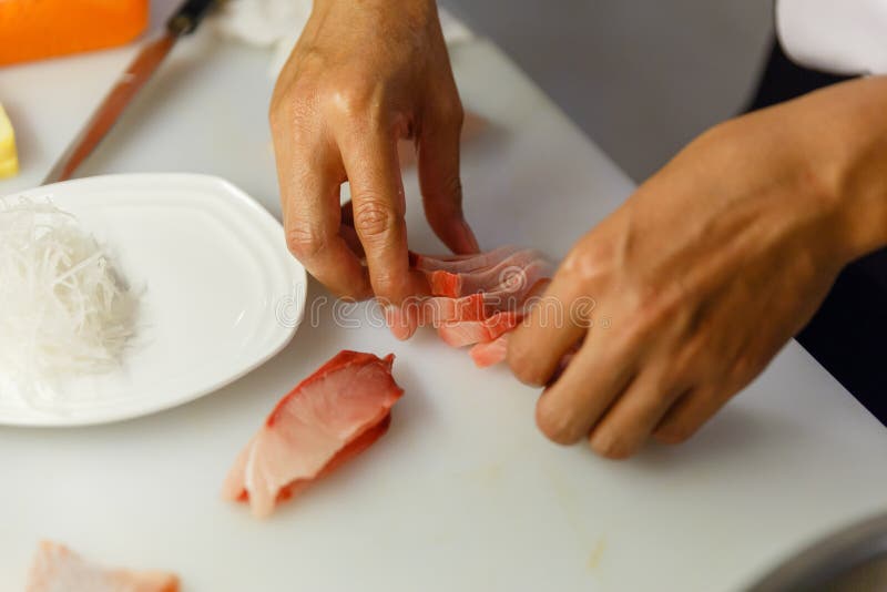 Preparing Sliced Hamachi Sashimi with Sliced Radish Stock Photo - Image ...