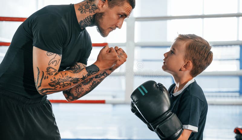 Preparing for the Sparring. Coach is Teaching the Boy Box Techniques ...