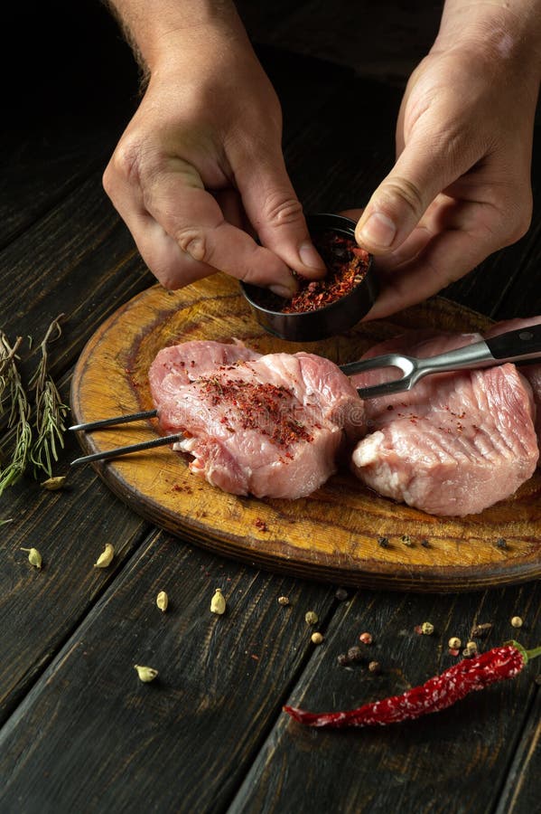 Preparing a Steak from Meat by the Hands of a Chef for a Barbecue. Raw ...
