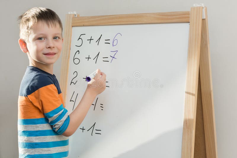 Preschool Boy Solves a Math Example by Writing the Answer on the Board ...