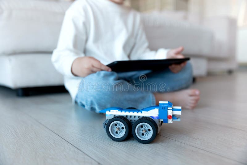 Preschool Child Uses Distant Controller on Tablet Pc To Drive Self-made ...