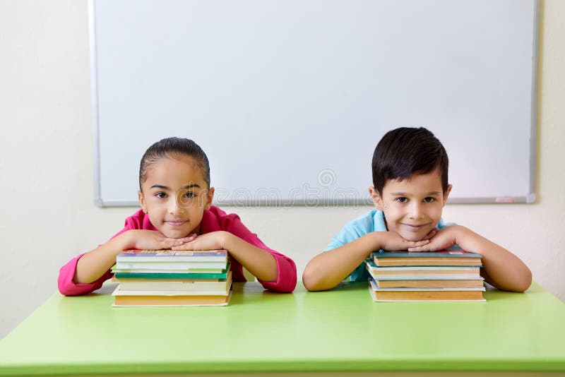 Preschool Children Playing with Books Sitting at a Table Stock Photo ...
