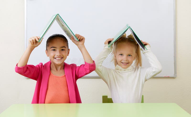 Preschool Children Playing with Books Sitting at a Table Stock Image ...