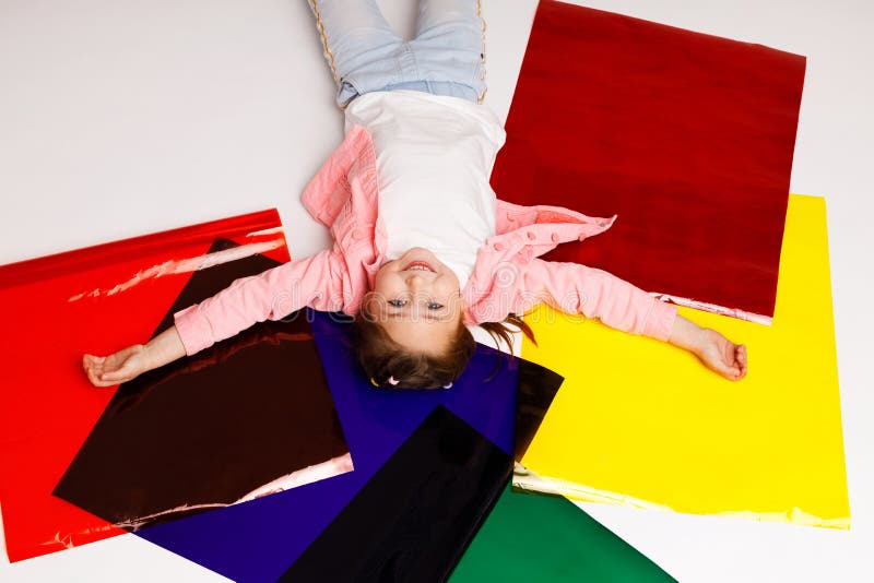 Preschool Girl Lying on Colored Foil Sheets and Learning Colors, Early ...