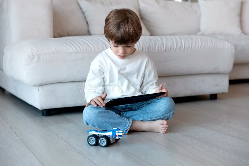 Preschool Child Uses Distant Controller on Tablet Pc To Drive Self-made ...