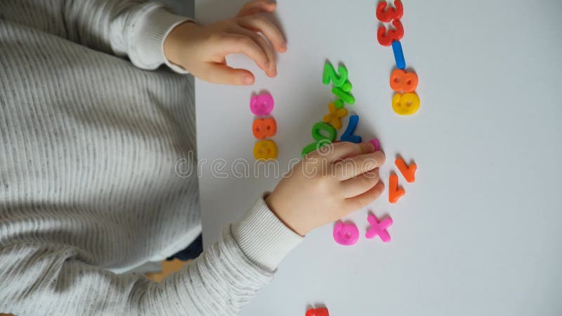 A Six-year-old Child Learns Math by Playing with Figures Numbers ...