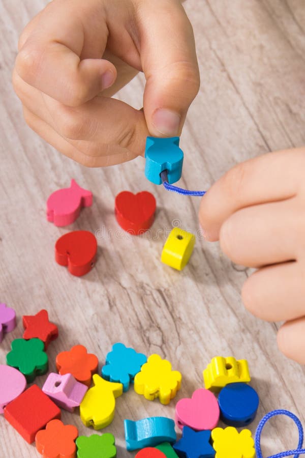 Preschooler Making Bracelet from Thread and Colored Beads. Development ...