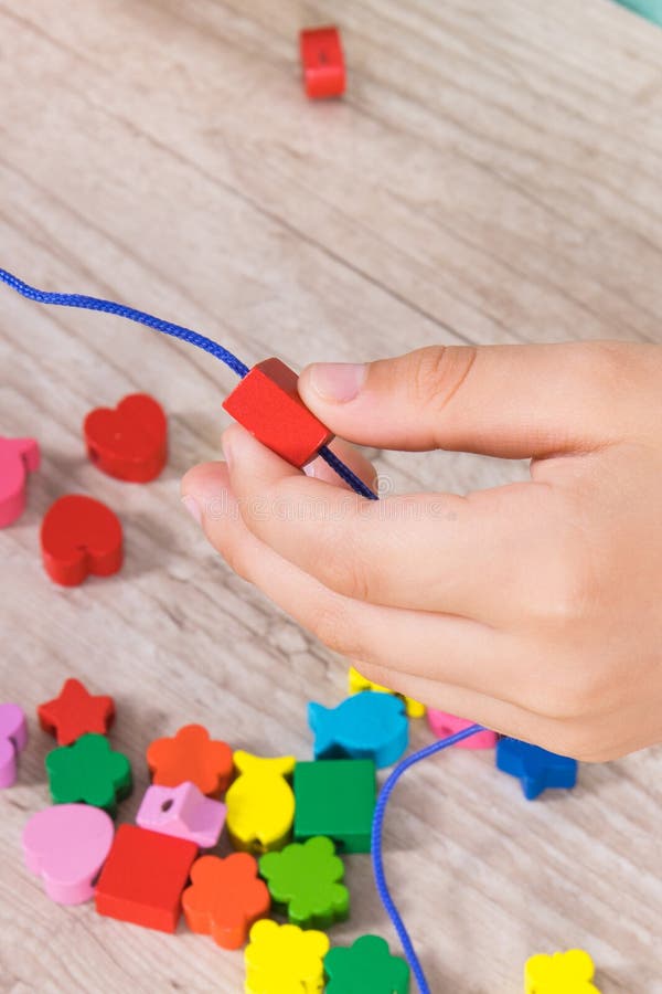 Preschooler Making Bracelet from Thread and Colored Beads. Development ...
