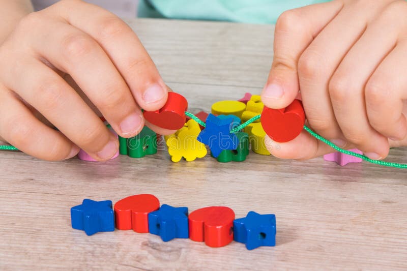Preschooler Making Bracelet from Thread and Colored Beads. Development ...