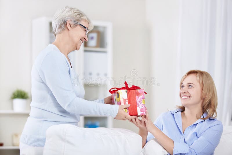 Young Woman Giving Present To Mother Smiling Stock Photo - Image of ...