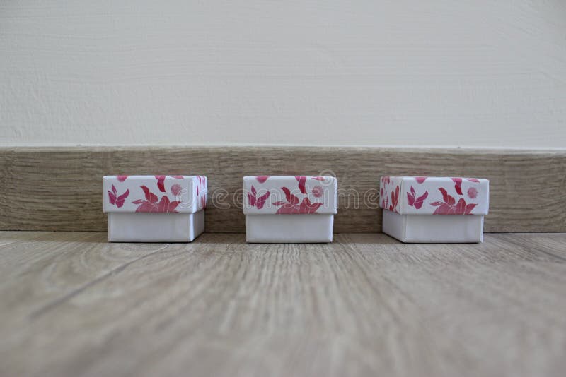 Three Little Present Boxes on a Wooden Floor for Holiday or Birthday ...