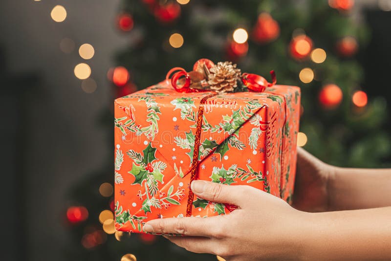 Present in Hands on the Background of a Decorated Christmas Tree Stock ...