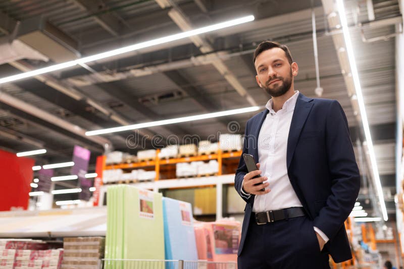Presentable Owner of a Hardware Store in a Business Suit Looks at the ...
