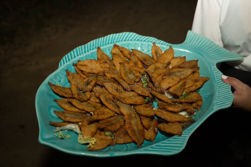 Presentation of a Fish-shaped Tray Filled with Fried Fish during a ...