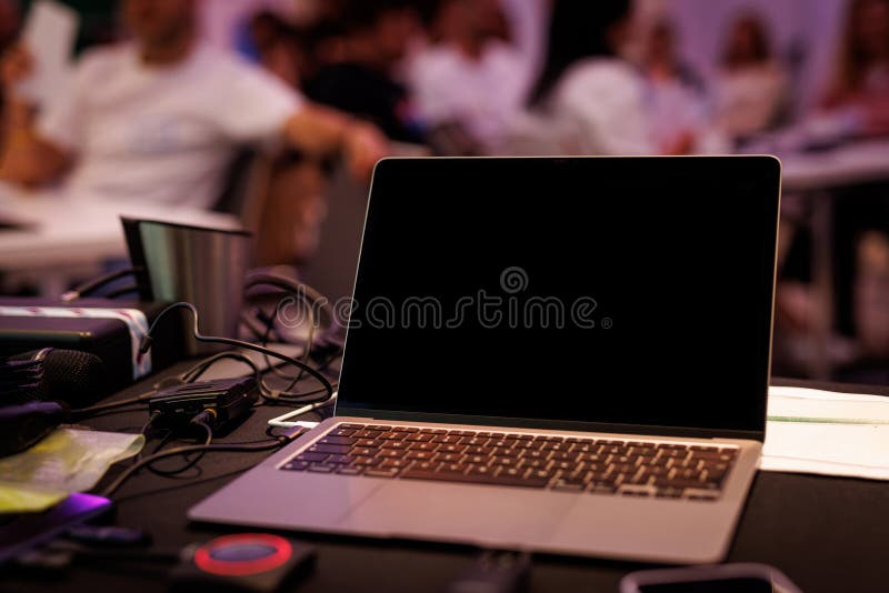 A Presenter Using a Laptop in a Conference Room with a Large Audience ...