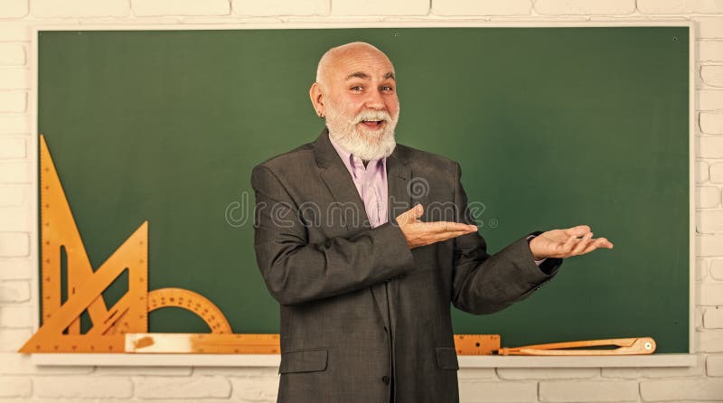 Presenting Product. Get Knowledge Here. Senior Man Teacher Use Math ...