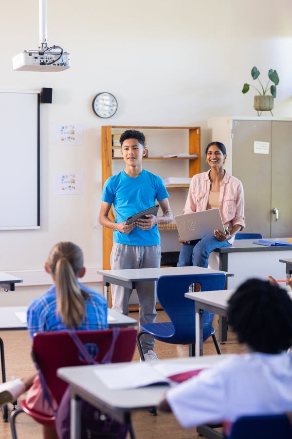 In School, Student Presenting Project To Classmates in Classroom ...