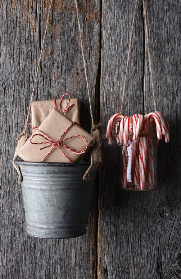 Presents and Candy Canes Hanging on Rustic Wall Stock Image - Image of ...