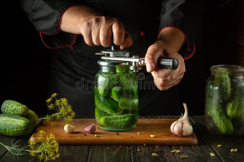 Preserving Cucumbers in a Jar with Spices. a Chef Uses a Hand Seamer To ...
