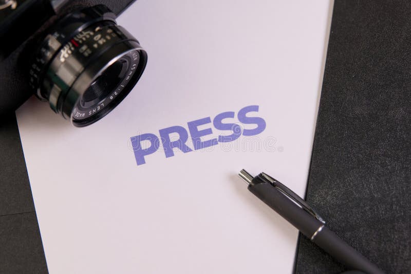Press Materials on Desk with Camera and Pen Ready for Use Stock Photo ...