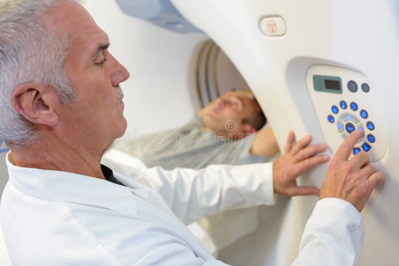 He pressing mri buttons stock photo. Image of expertise - 186141802