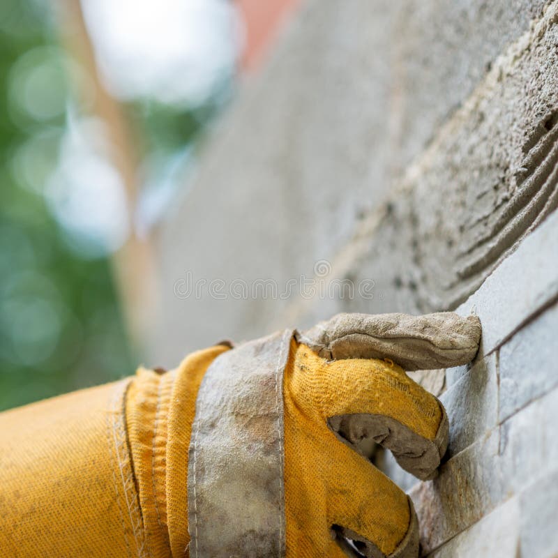 Pressing an Ornamental Tile into a Glue on a Wall Stock Photo - Image ...