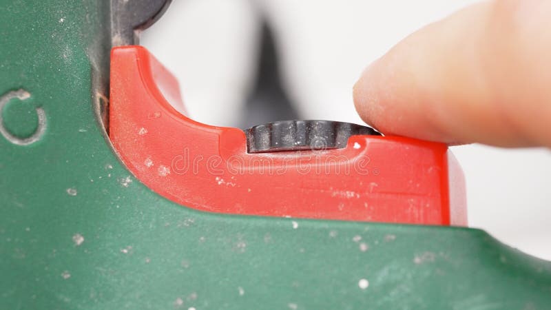 Pressing the Red Button on the Green Screwdriver. Stock Image - Image ...