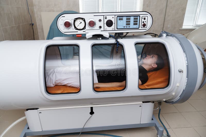 A Hyperbaric Chamber With A Man Lying Inside. Treatment In An Oxygen ...