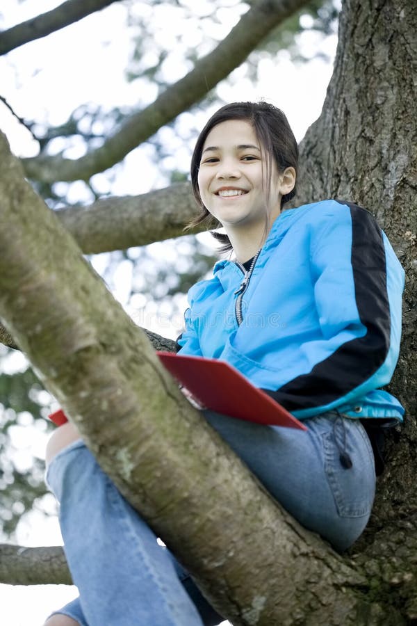 Preteen Girl Sitting in Tree Writing Stock Photo - Image of book, blue ...