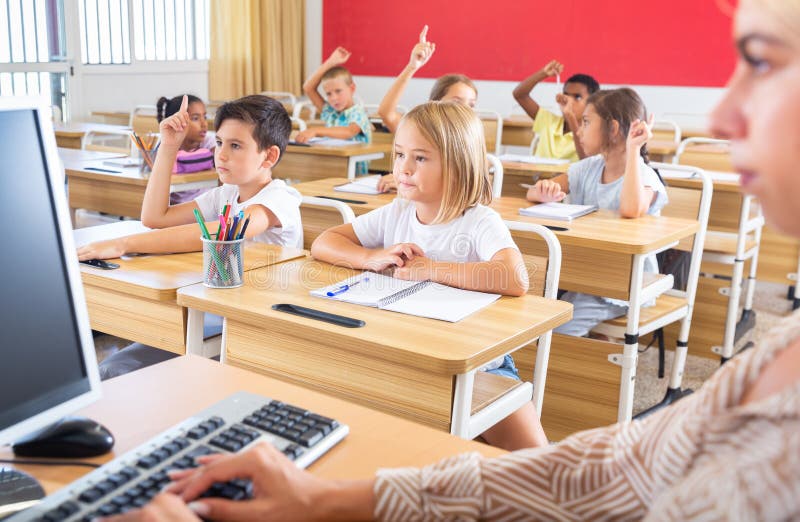 Preteen Schoolchildren Raising Hands To Answer during Lesson Stock ... Preteen Schoolchildren Raising Hands To Answer during Lesson Stock ...