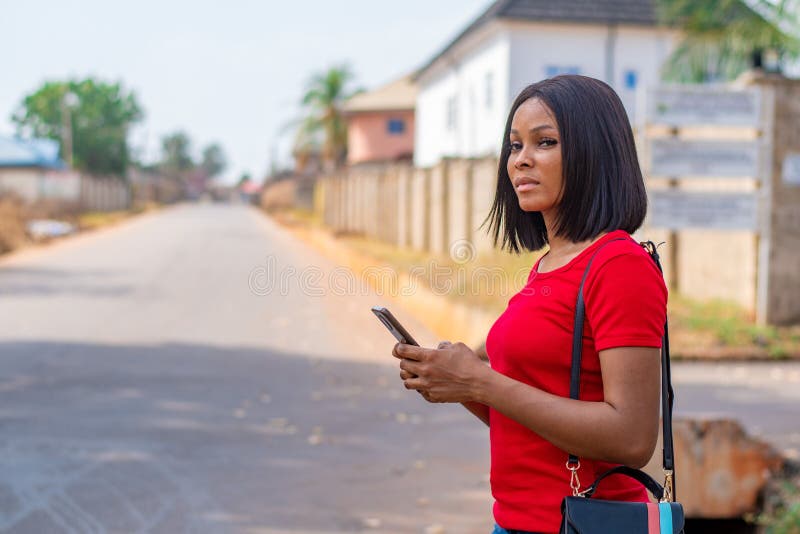 African Lady Roadside Holding Her Phone Stock Image - Image of phone ...