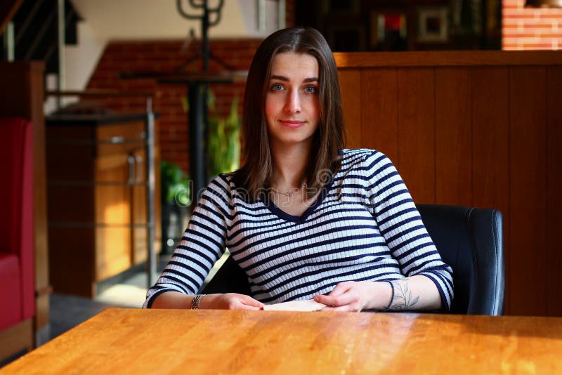 Pretty Alone Girl is Sitting at the Table in the Restaurant Stock Image ...
