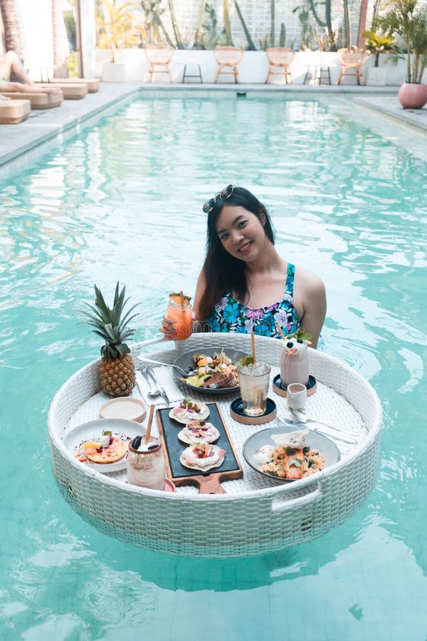 Pretty Asian Woman Eating Breakfast in the Pool Stock Photo - Image of ...