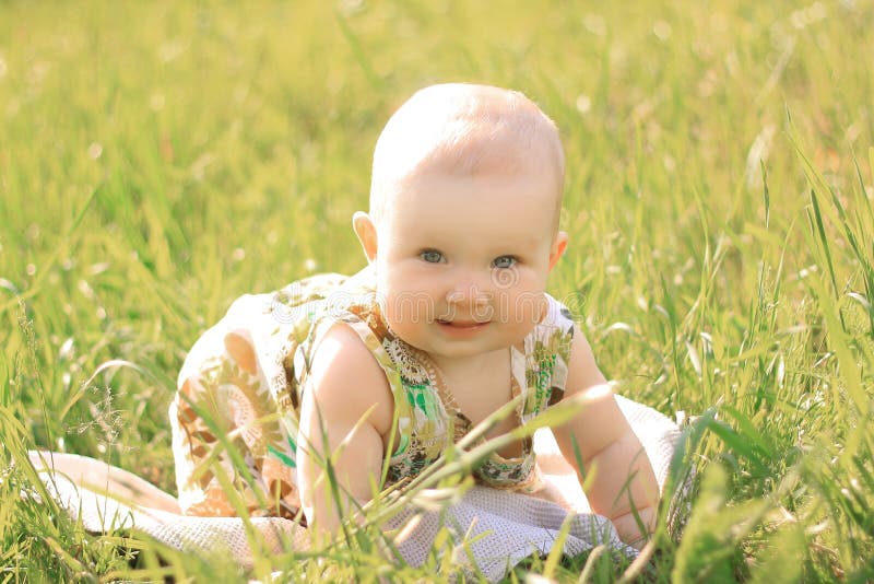 Pretty Baby Girl on the Lawn in the Spring Day Stock Photo - Image of ...