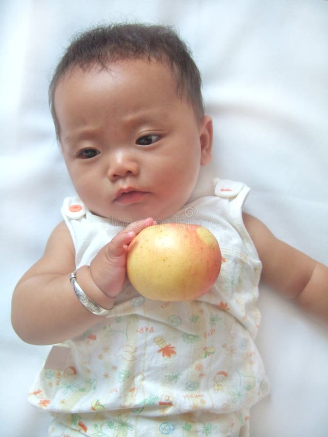 Pretty baby and red apple stock image. Image of child - 6557877
