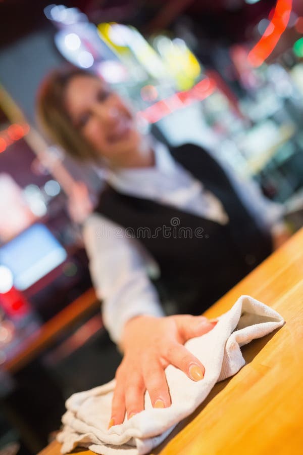 Pretty Barmaid Wiping Down Bar Stock Photo - Image of drink, shirt ...