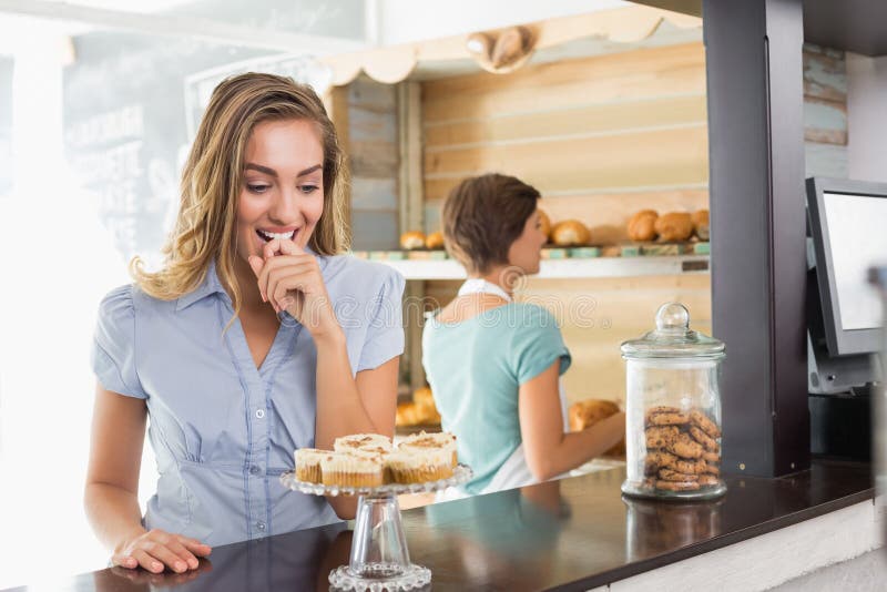 Pretty Blonde Being Tempted by Cupcakes Stock Image - Image of female ...