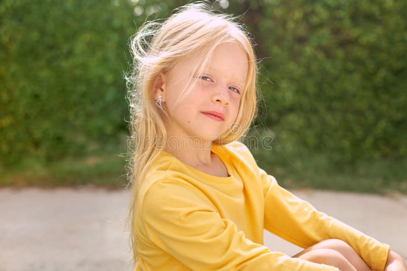 Pretty Blonde Girl Yellow T Shirt Sitting Before Green Wall Top View