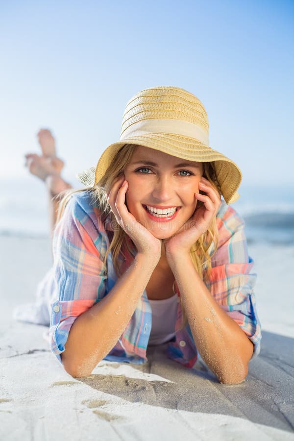 Pretty Blonde Smiling at Camera at the Beach Lying on the Sand Stock ...