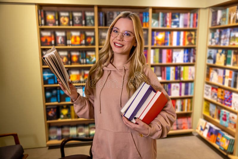 Pretty Blonde Woman Standing with Books in Library Stock Image - Image ...