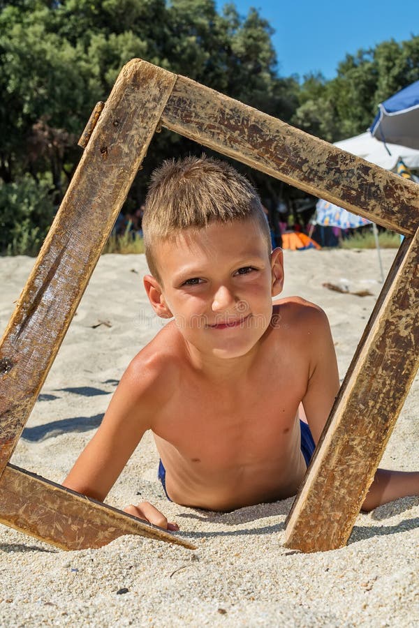 Pretty Boy on Beach with Wooden Picture Frame Stock Photo - Image of ...
