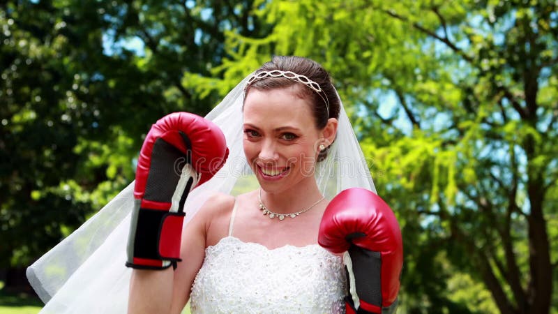 Pretty Bride Smiling at Camera and Wearing Boxing Gloves Stock Video ...