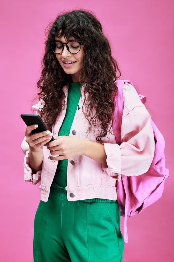Pretty Brunette Student with Pink Backpack Scrolling in Mobile Phone ...