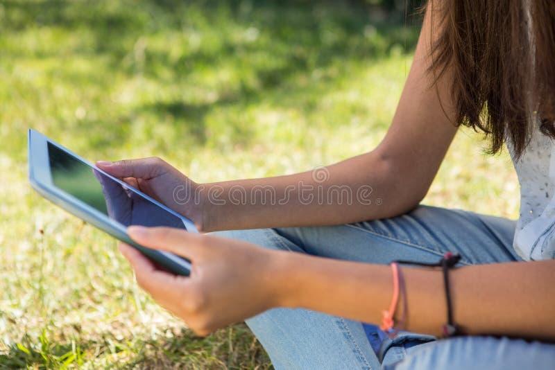 Pretty Brunette Using Tablet in Park Stock Photo - Image of touchscreen ...
