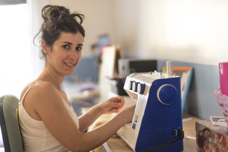 Pretty Brunette Woman Sewing in Machine at Home Stock Photo - Image of ...