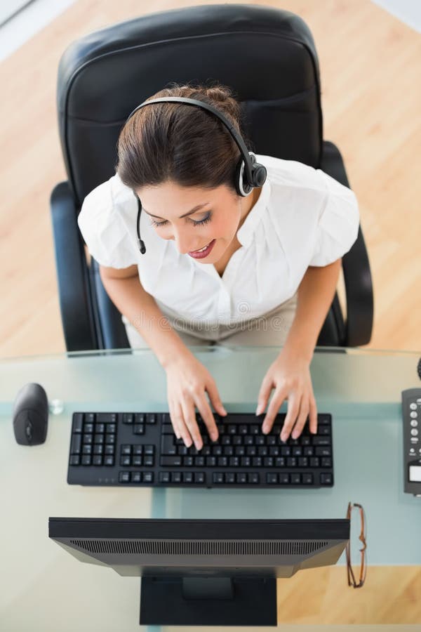 Pretty Call Center Agent Typing while on a Call Stock Photo - Image of ...