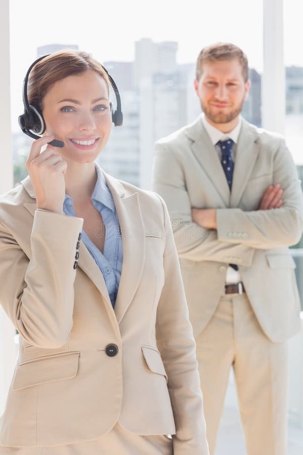 Pretty Call Centre Agent with Colleague Behind Her Stock Photo - Image ...