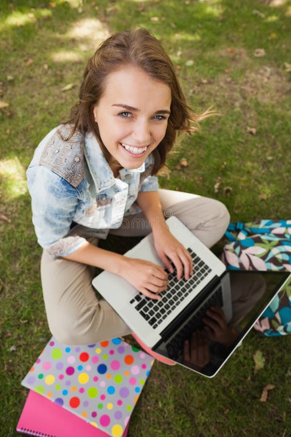 Pretty Cheerful Student Sitting on Grass Using Laptop Stock Image ...